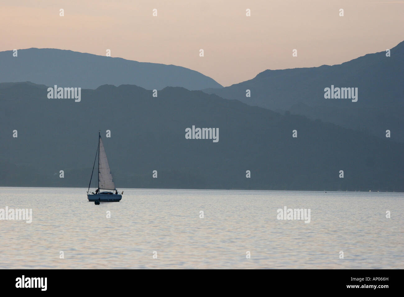 A sail boat on Lake Windermere at sunset, landscape Stock Photo - Alamy