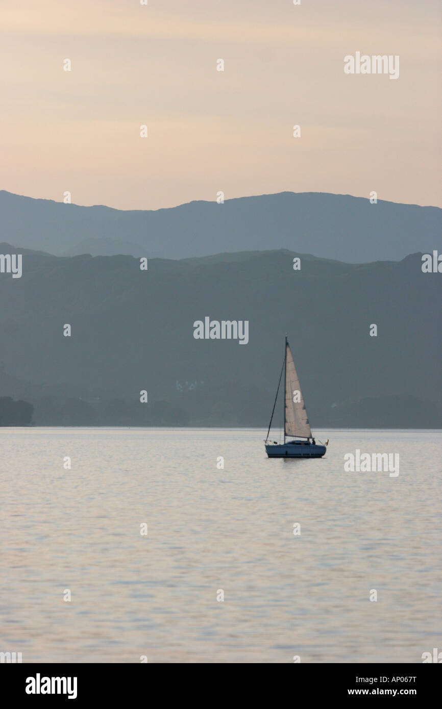 A sail boat on Lake Windermere at sunset, portrait Stock Photo - Alamy