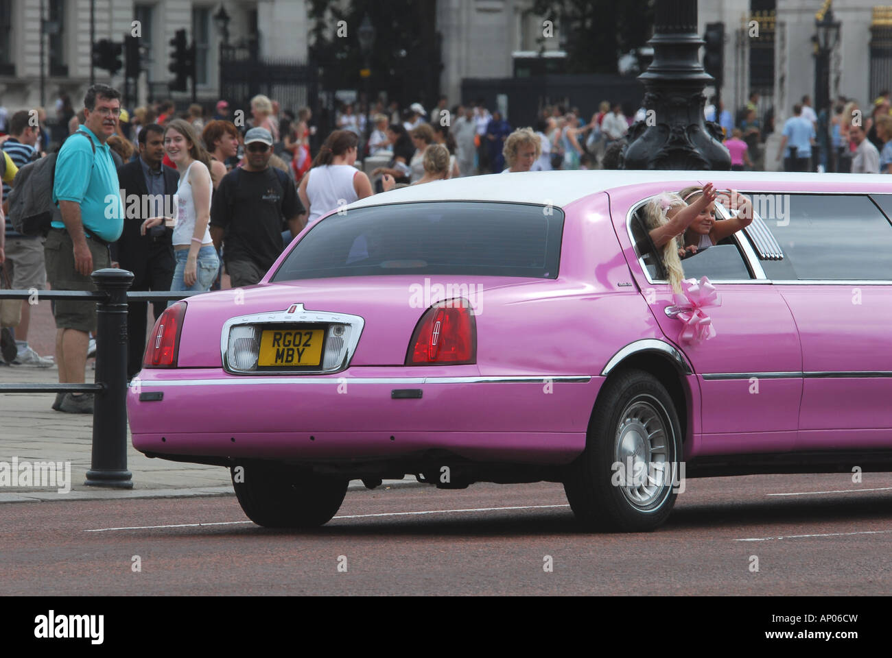 A teenage girl in a stretched limousine waving to the public in London ...