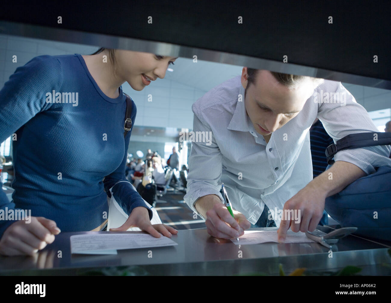 Two people filling in forms Stock Photo - Alamy