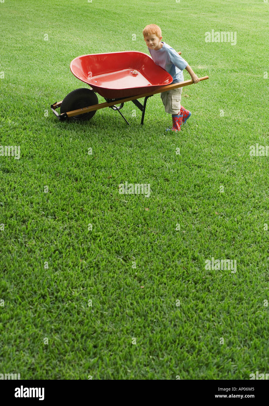 Children pushing wheelbarrows hi-res stock photography and images - Alamy