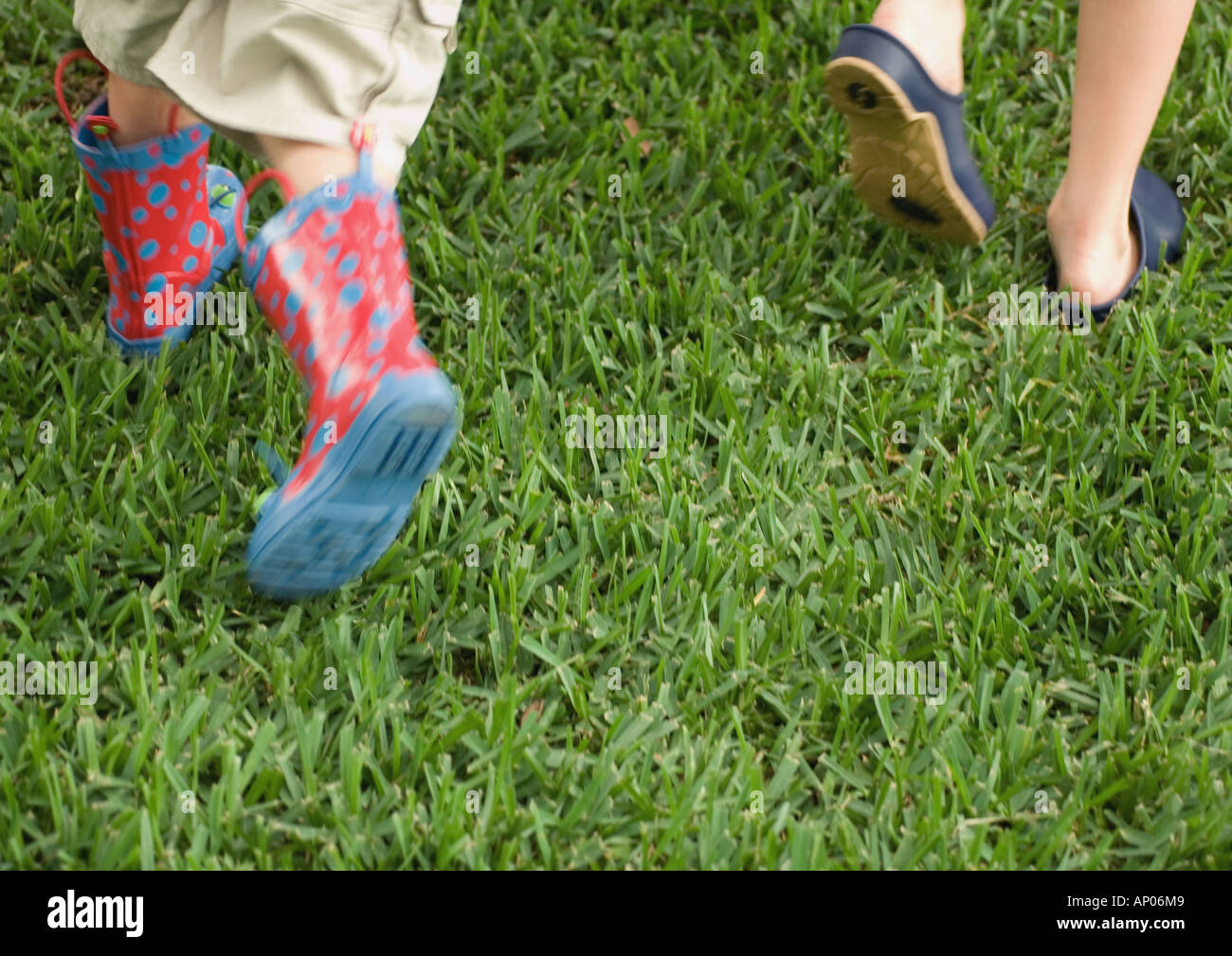 Two children running across grass, close-up of feet Stock Photo - Alamy