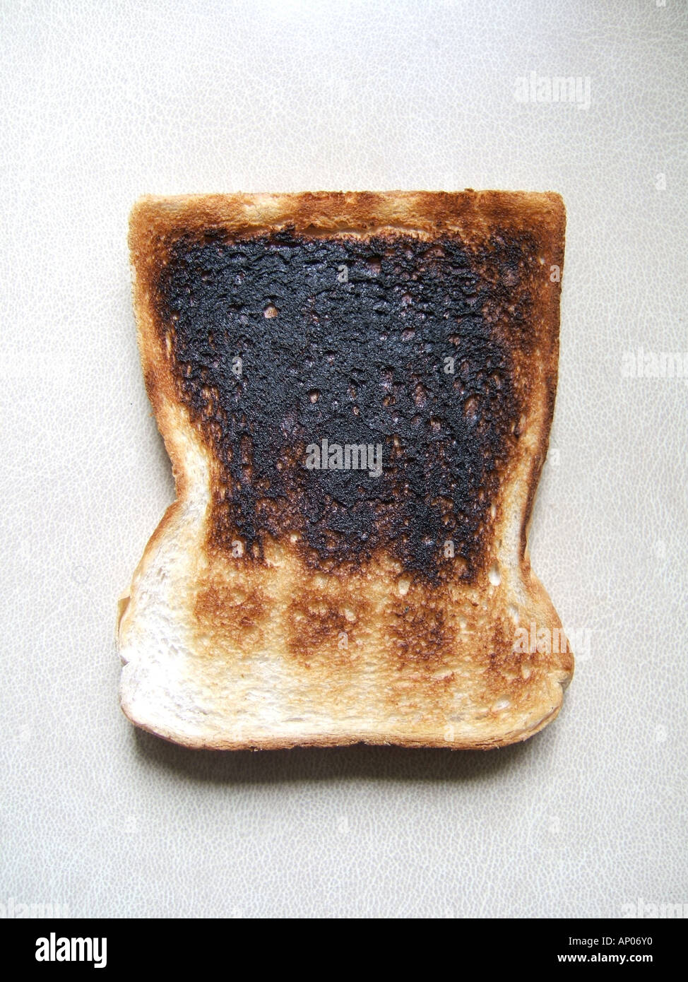 one slice of burnt toast on kitchen work top Stock Photo - Alamy