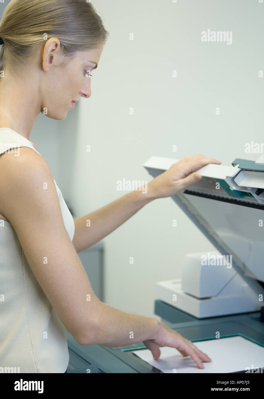 Woman making photocopies in office Stock Photo - Alamy
