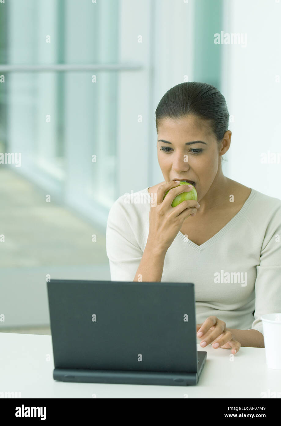 Woman multitasks using laptop hi-res stock photography and images - Alamy