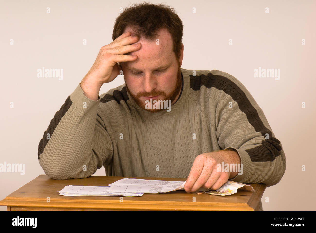 man looking at bank statements, money worries Stock Photo - Alamy