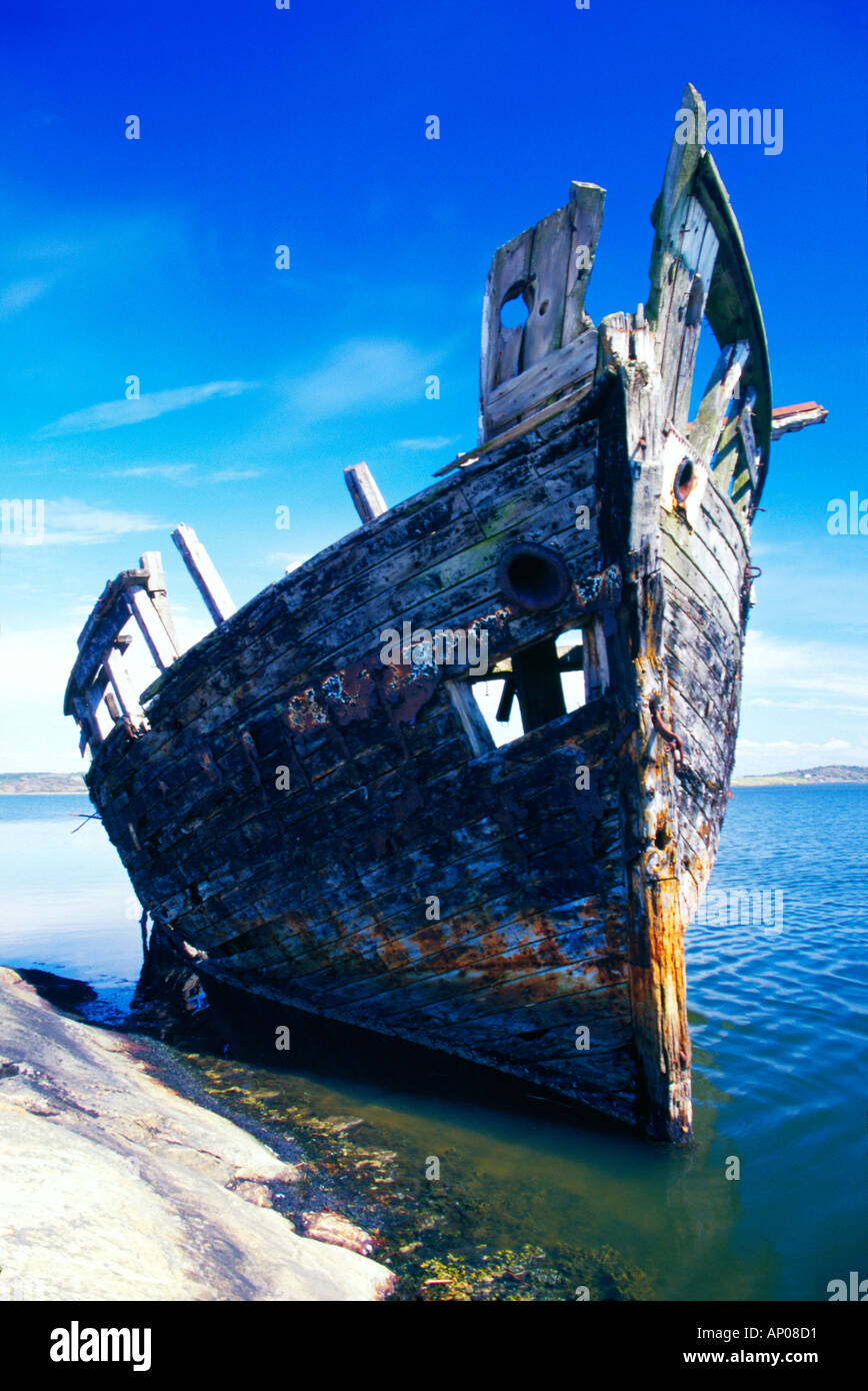 Boat shell lying aground in the shallow water of Northern archipelago ...