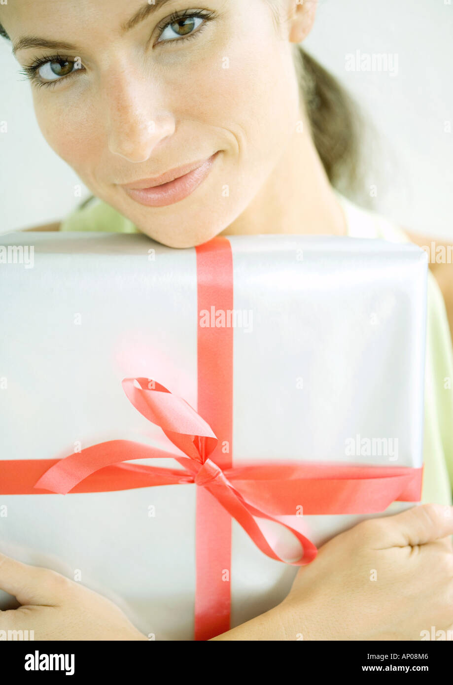 Woman holding present in arms Stock Photo - Alamy