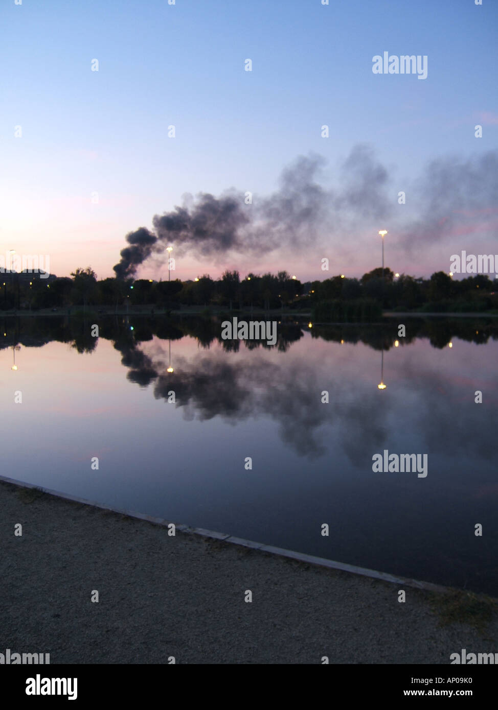 trail of black smoke on landscape skyline at night Stock Photo - Alamy