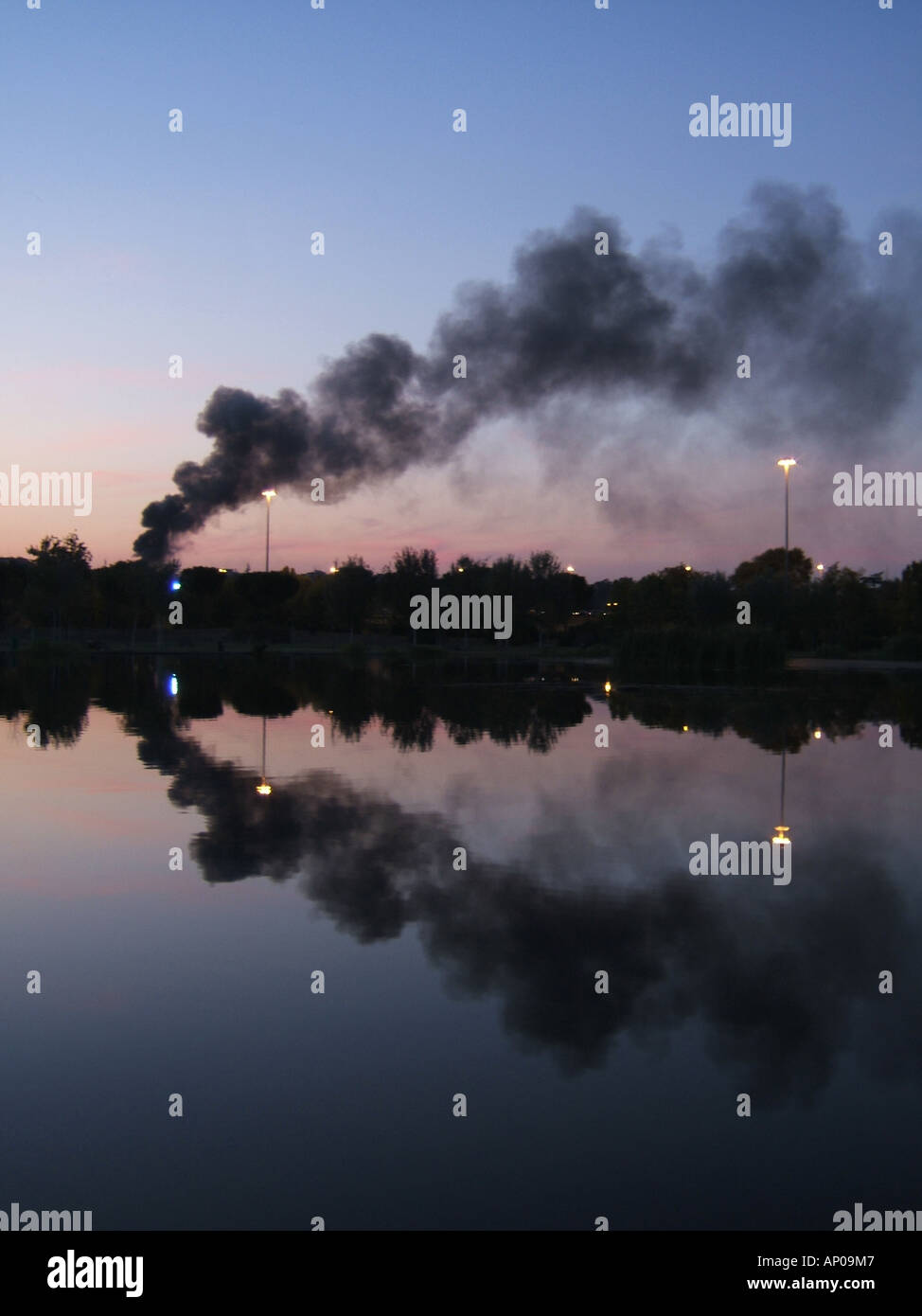 trail of black smoke on landscape skyline at night Stock Photo - Alamy