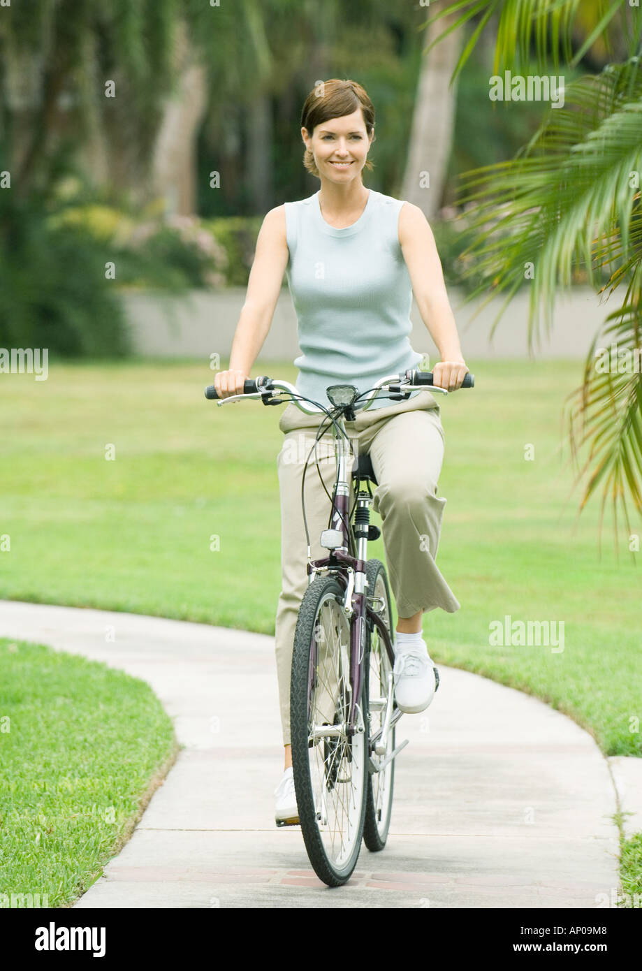 Woman on bike, smiling Stock Photo - Alamy