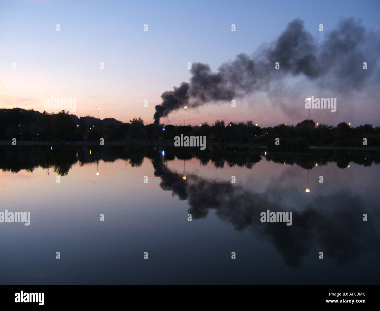 trail of black smoke on landscape skyline at night Stock Photo - Alamy