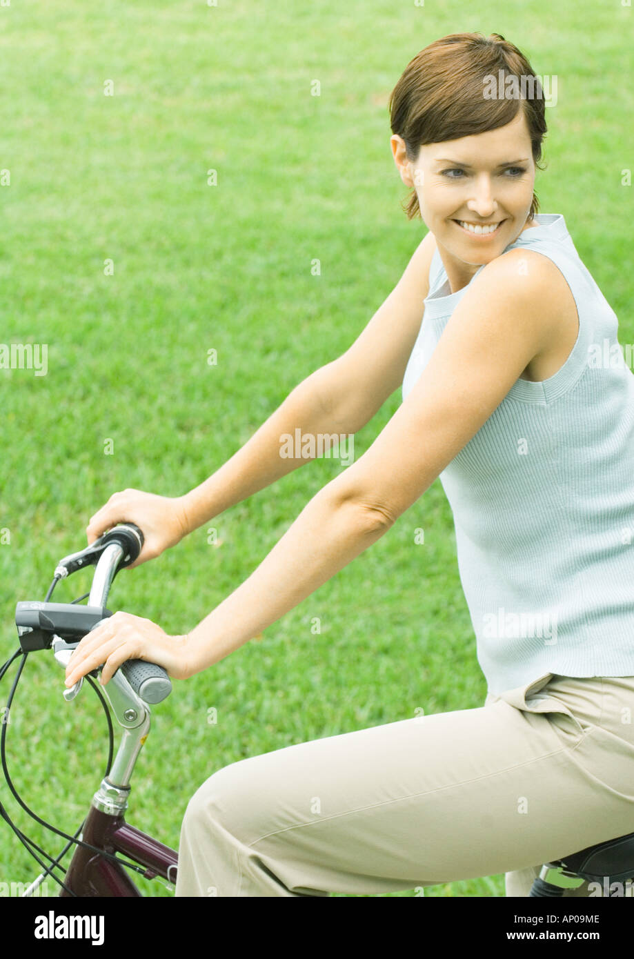 Woman on bike, smiling Stock Photo - Alamy