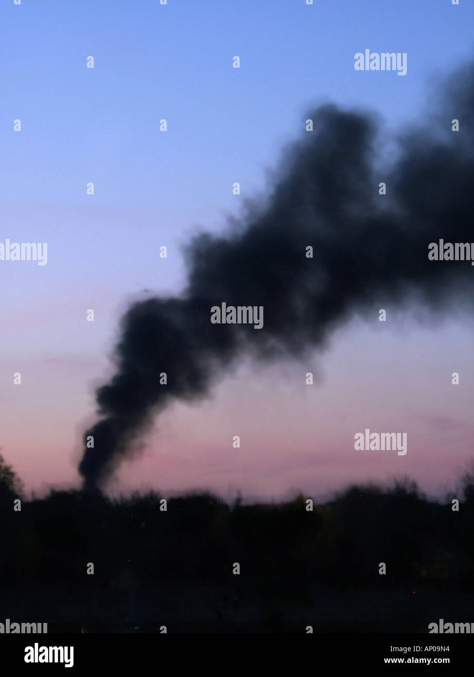 trail of black smoke on landscape skyline at night Stock Photo - Alamy