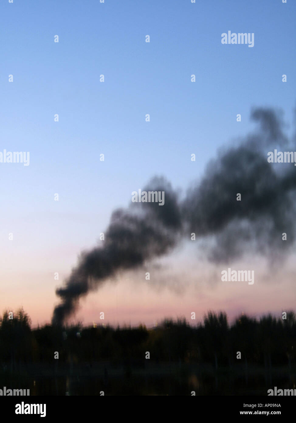trail of black smoke on landscape skyline at night Stock Photo - Alamy