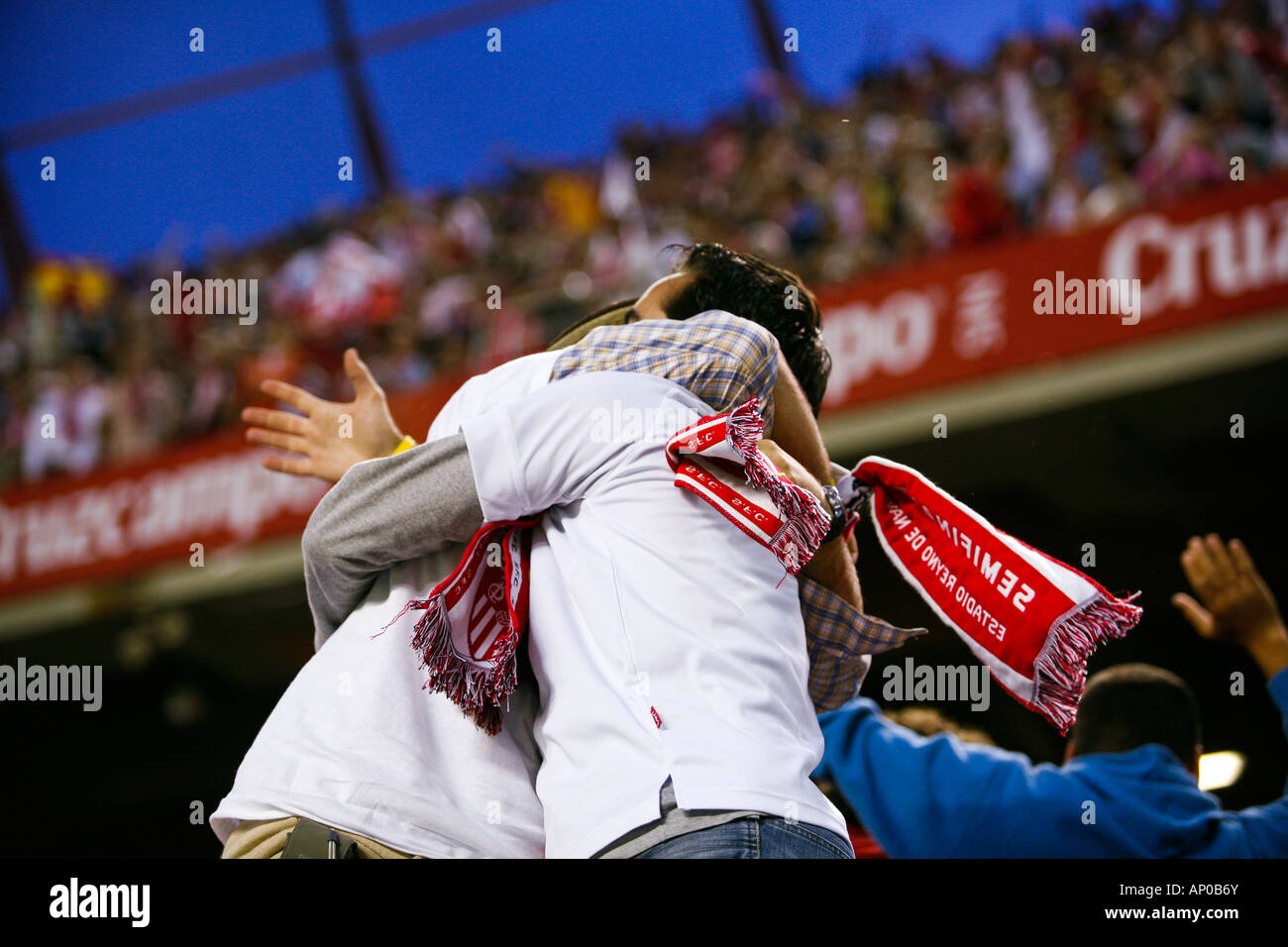 Sevilla FC fans hugging to celebrate a goal scoring Stock Photo - Alamy