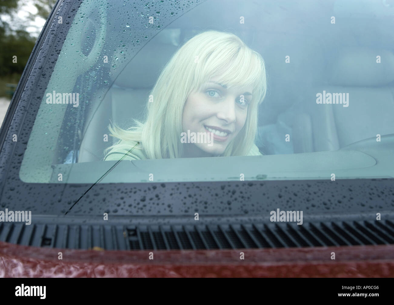 Woman in car, seen through windshield Stock Photo - Alamy