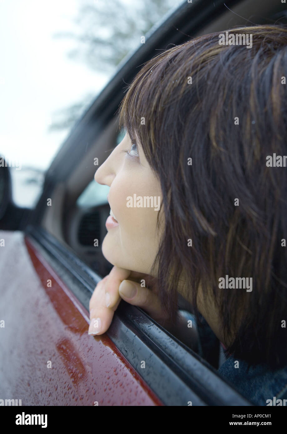 Woman looking out of car window Stock Photo - Alamy