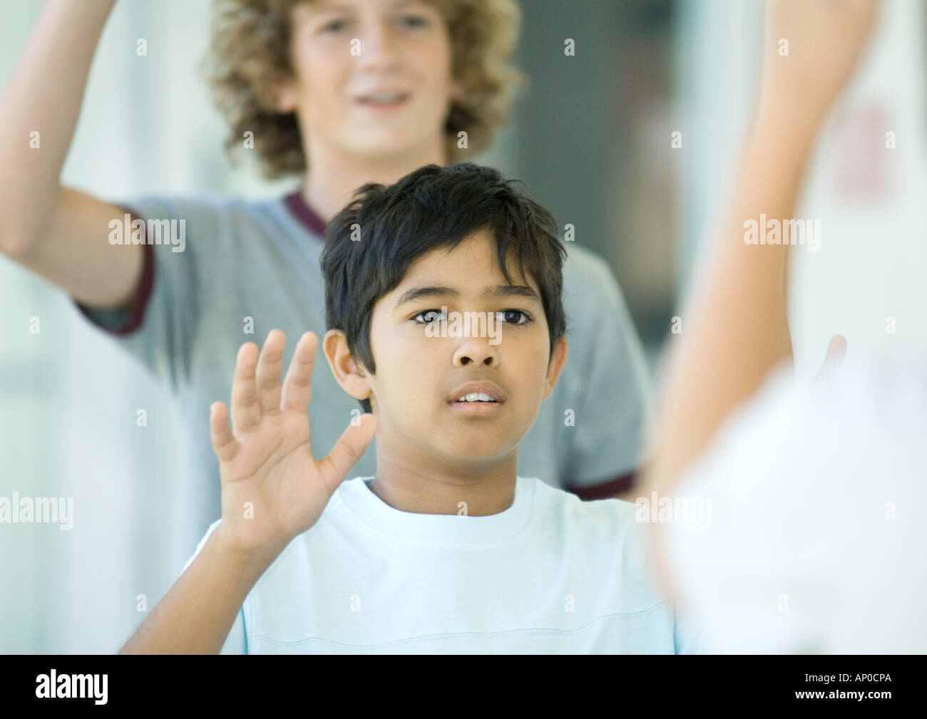 Preteen boys waving Stock Photo - Alamy