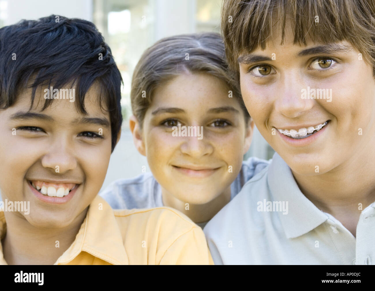 Three preteen kids smiling Stock Photo - Alamy
