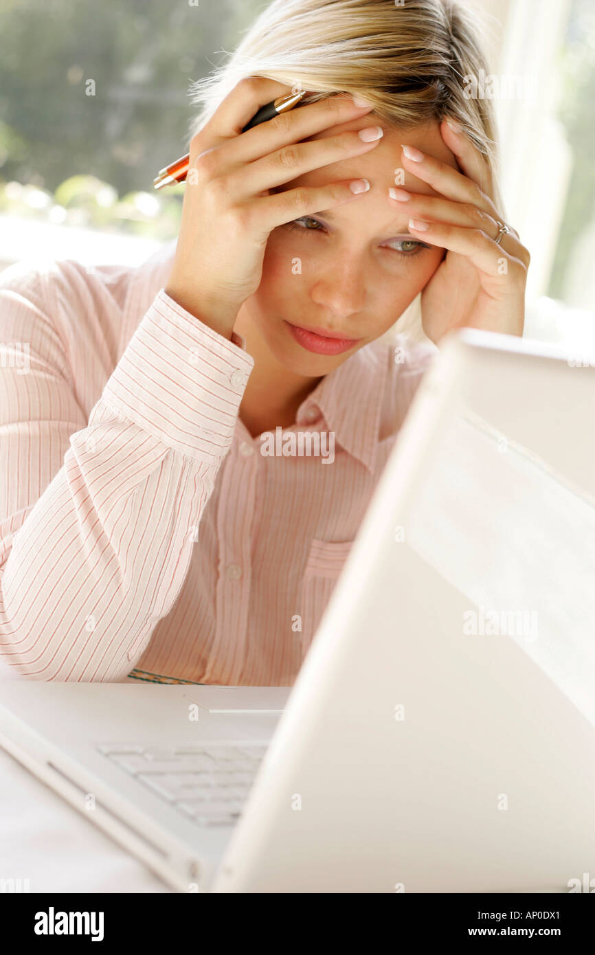 Girl looking worried at work using computer Stock Photo - Alamy
