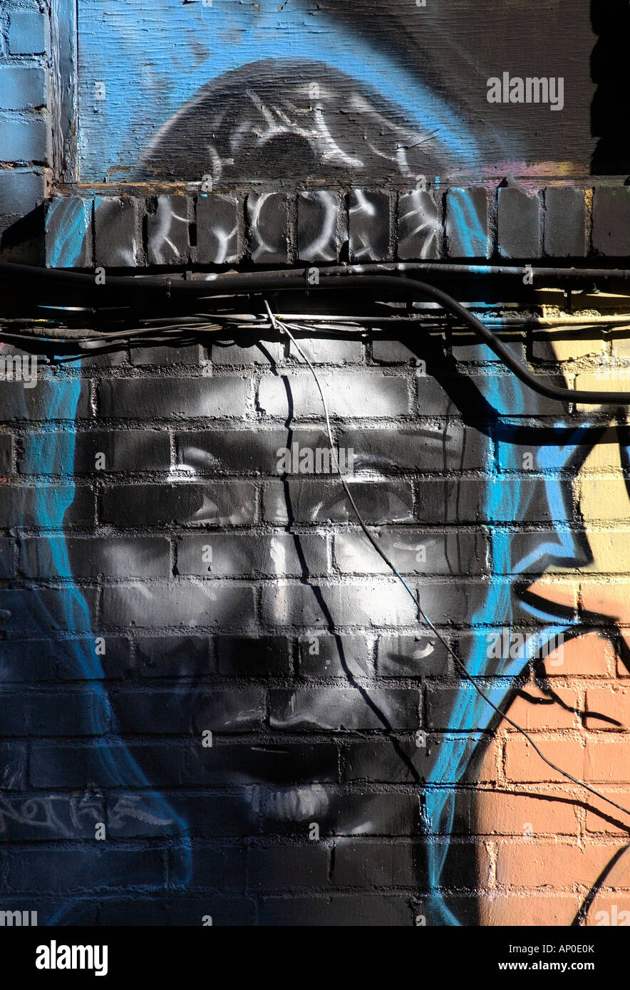 Graffiti off face on brick wall off Catherine Street. Montreal, Quebec ...