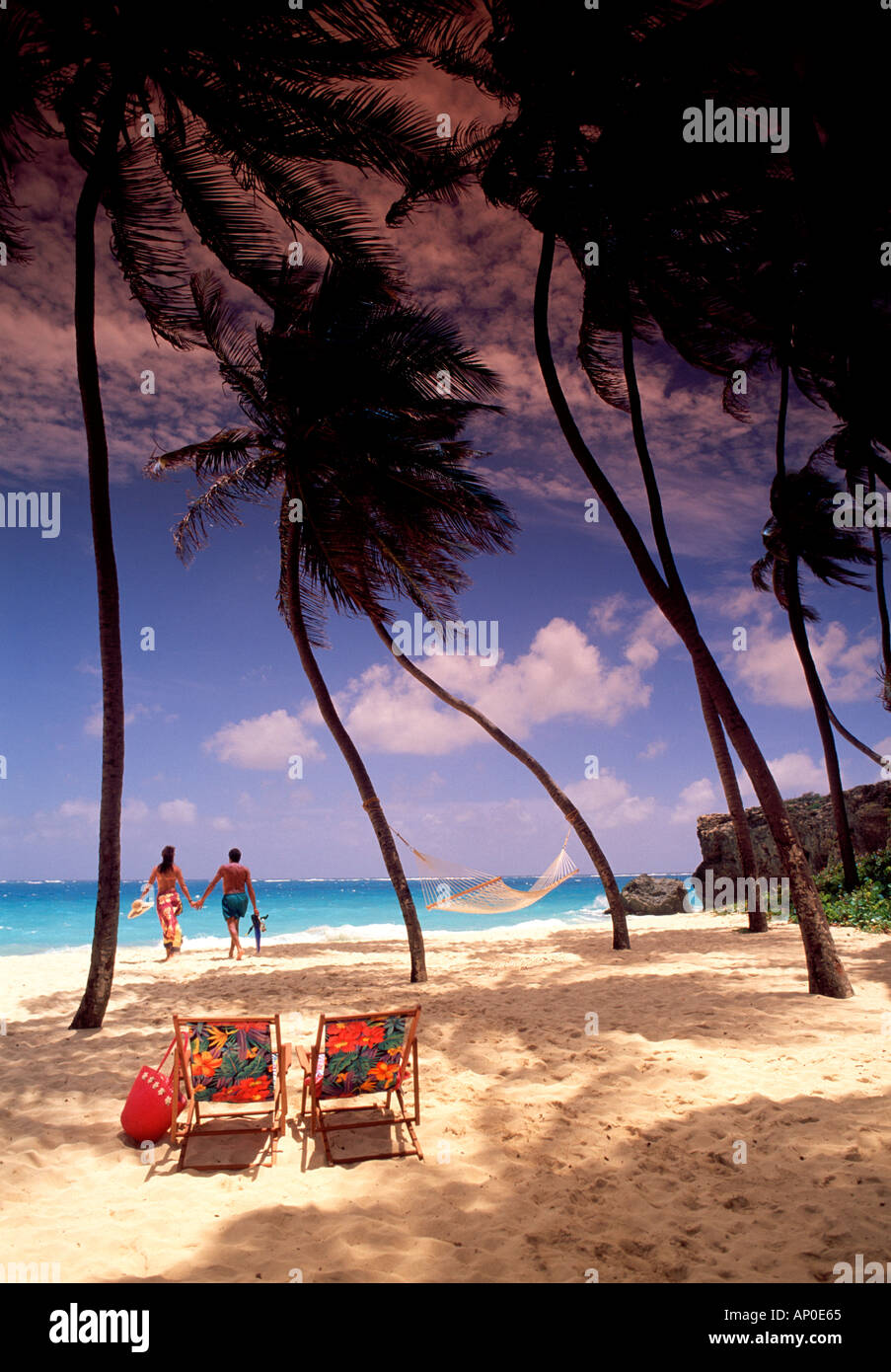 A couple strolls hand in hand toward the Caribbean at Bottom Bay on the ...