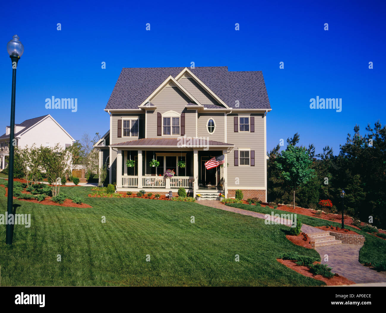 Front view of a large brown two story house with white trim and a large ...