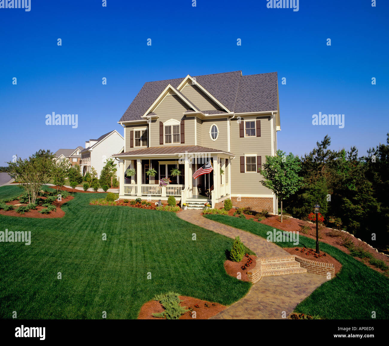 Front view of a large brown two story house with white trim and a large ...