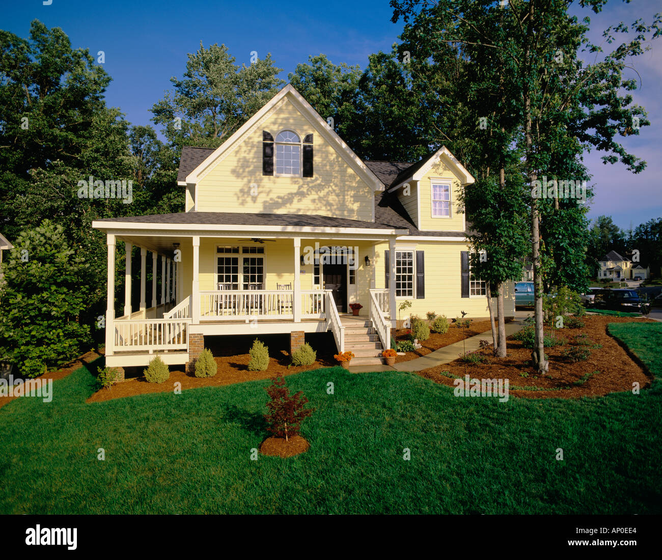Yellow House With A Large Yard and porch Stock Photo - Alamy