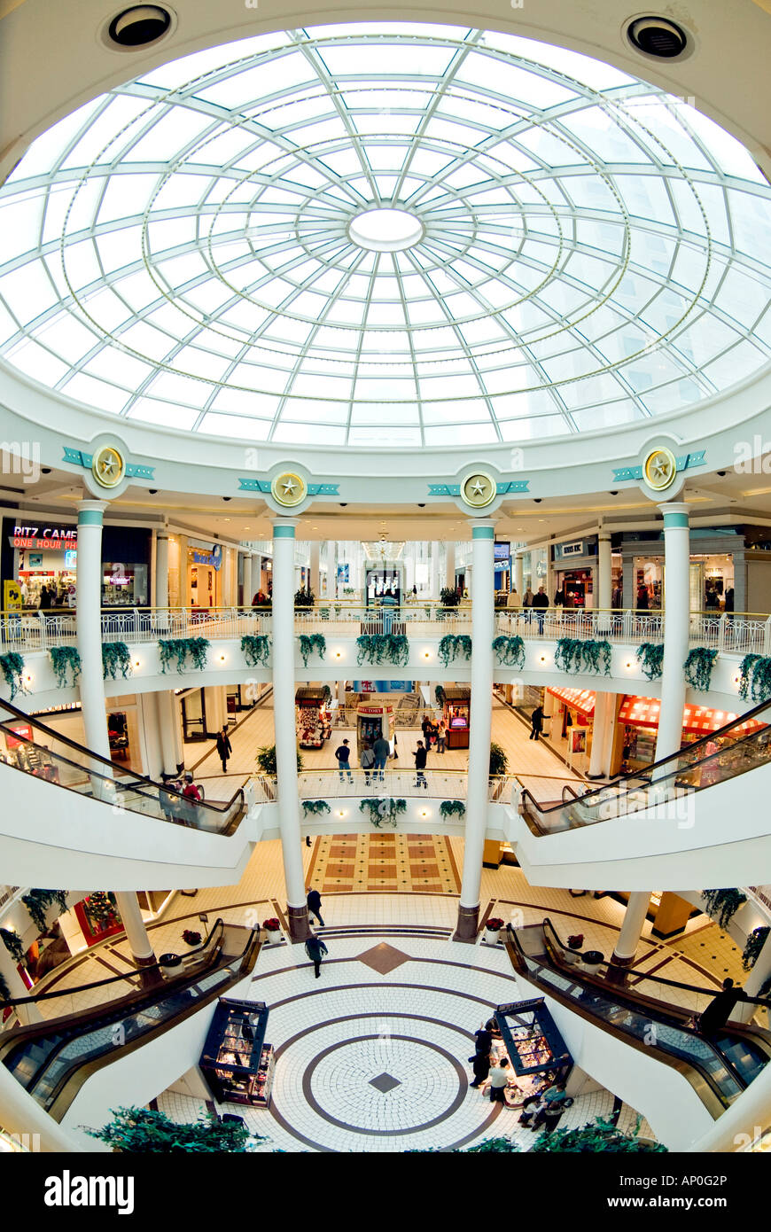 Extreme wide angle of a shopping mall at Christmas with escalators and ...