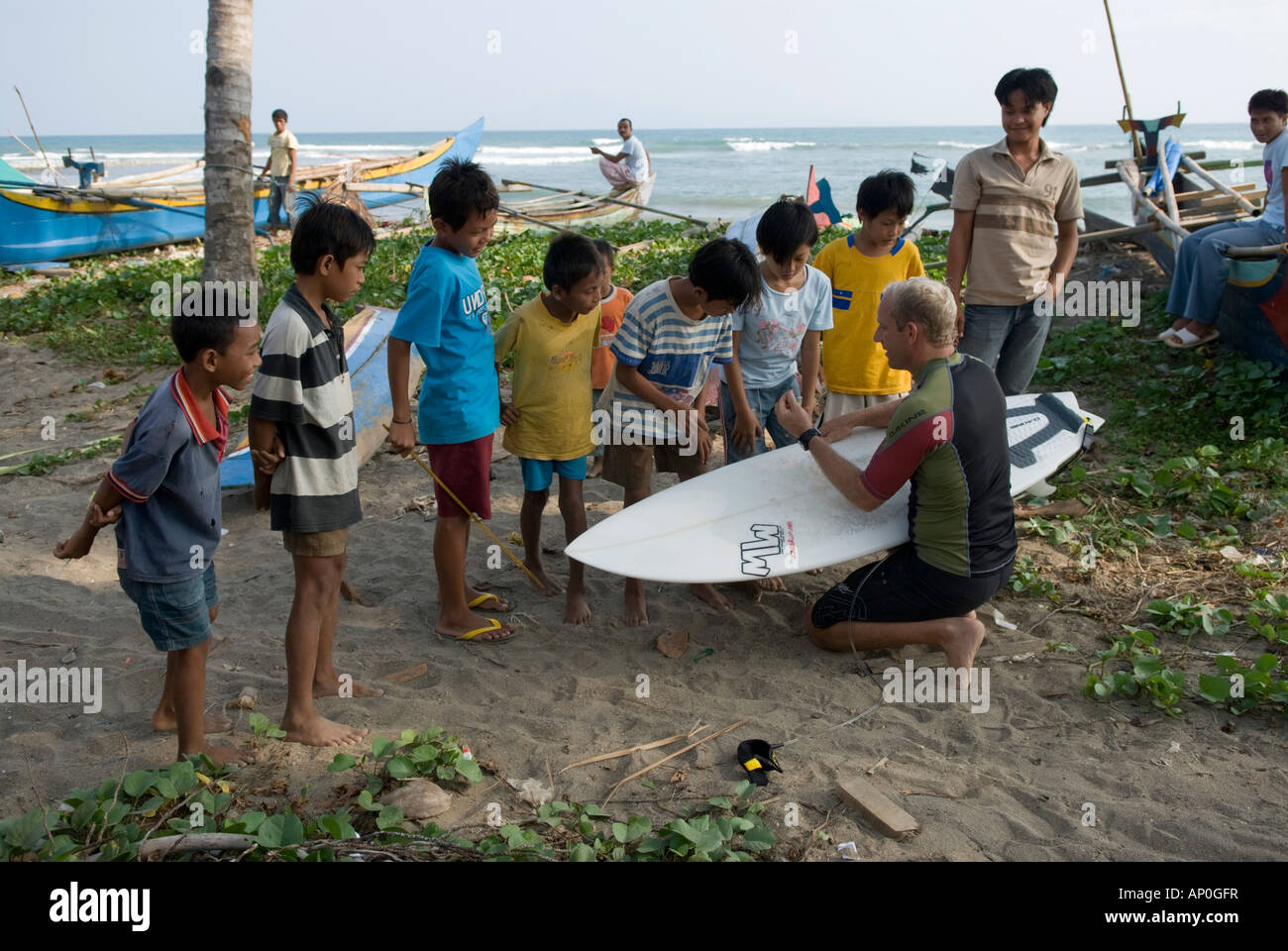 Surfer and children S Sumatra Indonesia Stock Photo - Alamy