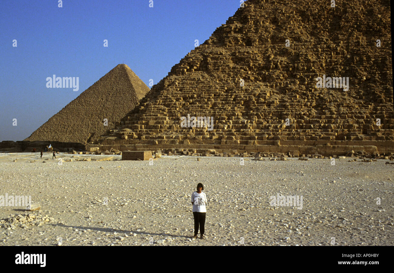 A traveler stands in front of the mighty pyramids in Giza Egypt Stock ...