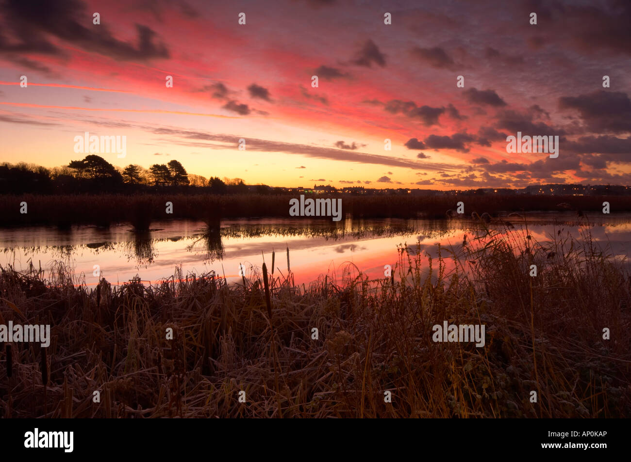 Colourful sunrise over Radipole nature reserve in Weymouth Dorset UK ...