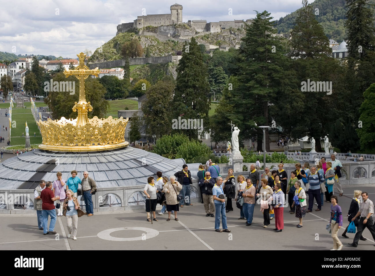 Pilgrims gathered near golden cross and crown on dome of the Basilica ...