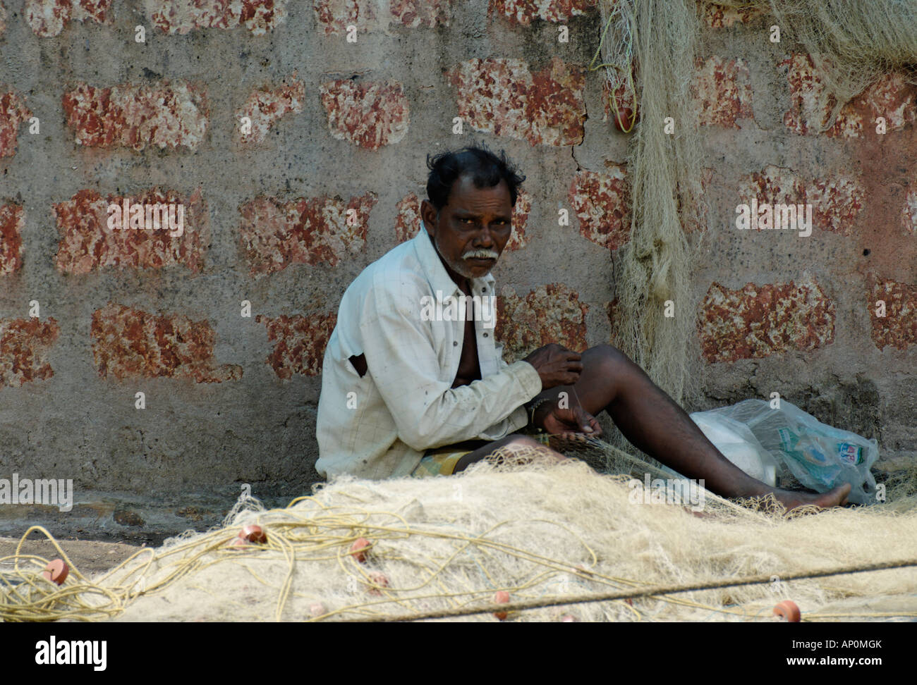 Mending a fishing net hi-res stock photography and images - Alamy