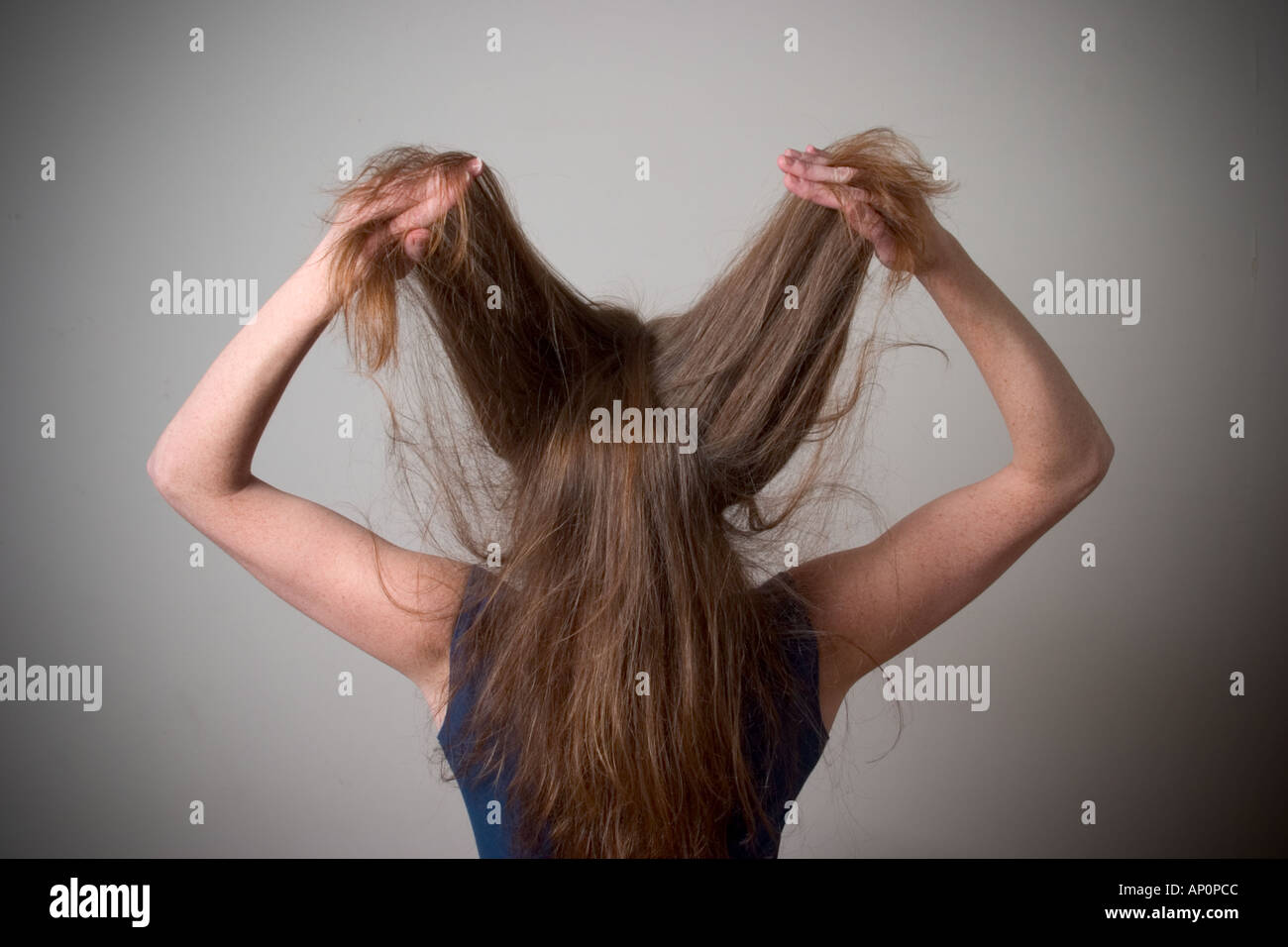 Woman posed from the back holding up her hair Model Released Stock ...