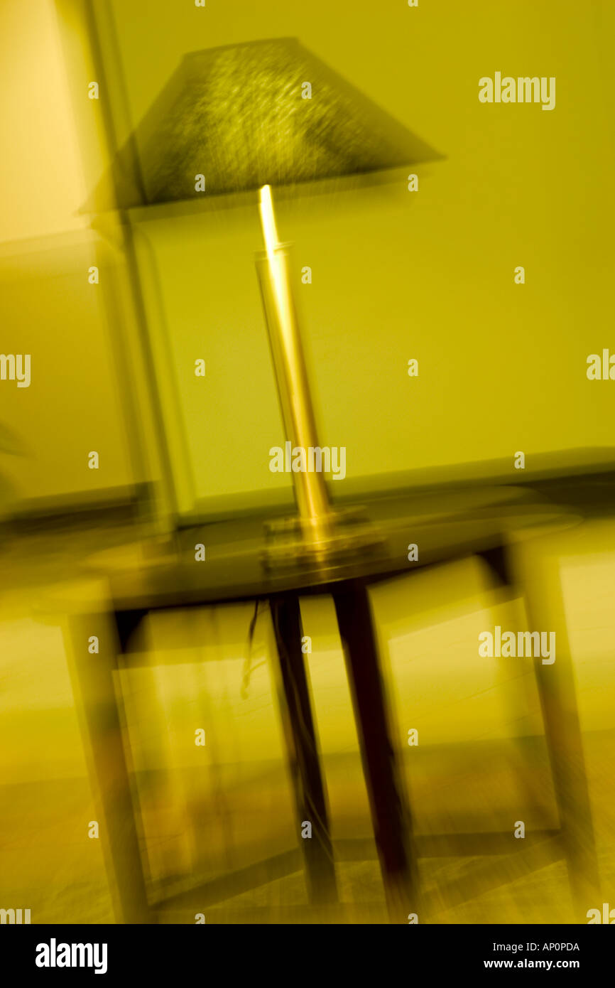 Lamp sitting on a small wood table Stock Photo - Alamy