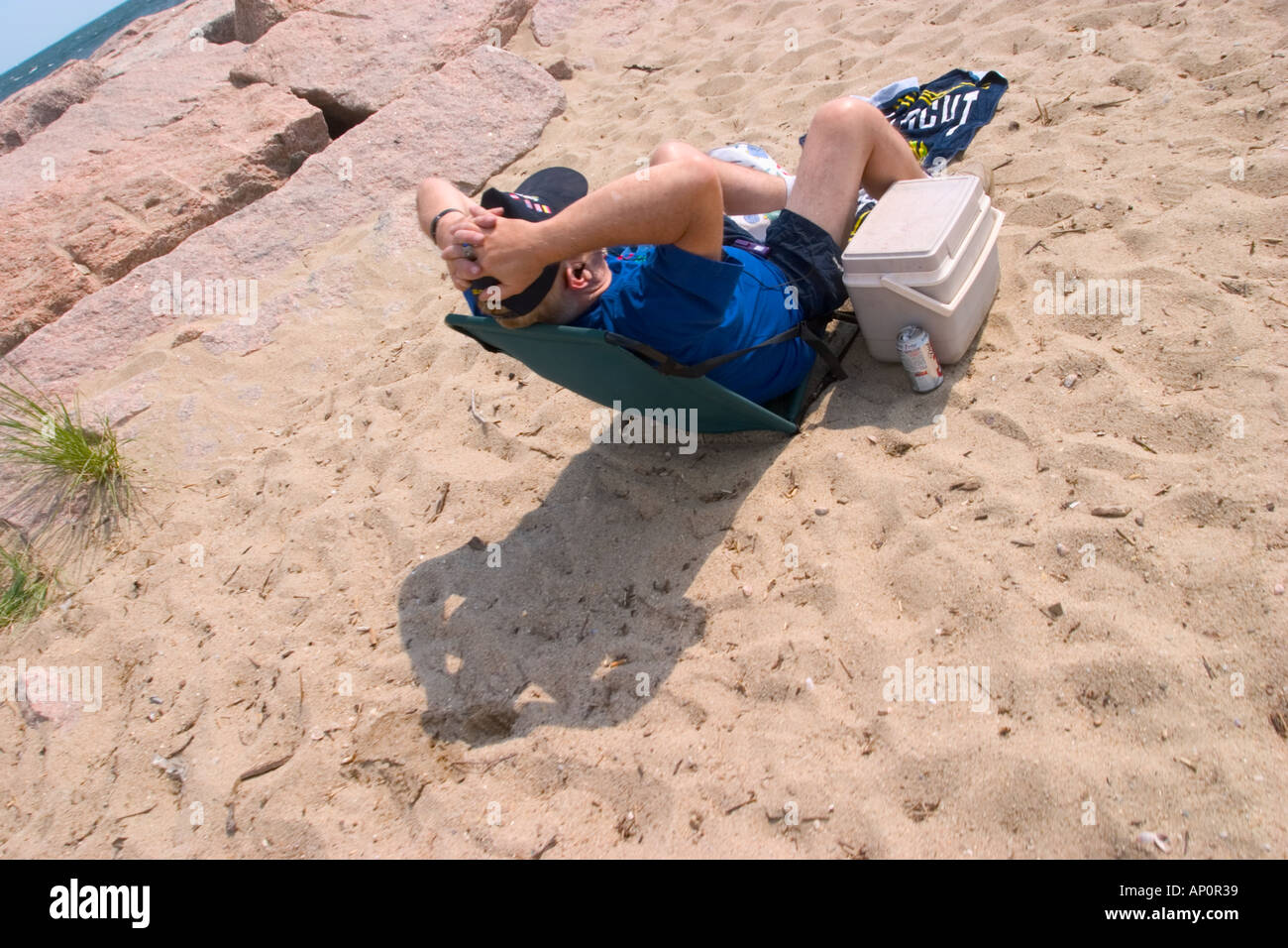 Man sitting at the beach in a folding chair hi-res stock photography ...