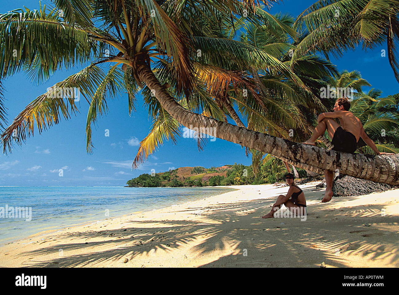 Couple sitting on the beach, Ile aux Nattes, Ste Marie, Madagascar ...