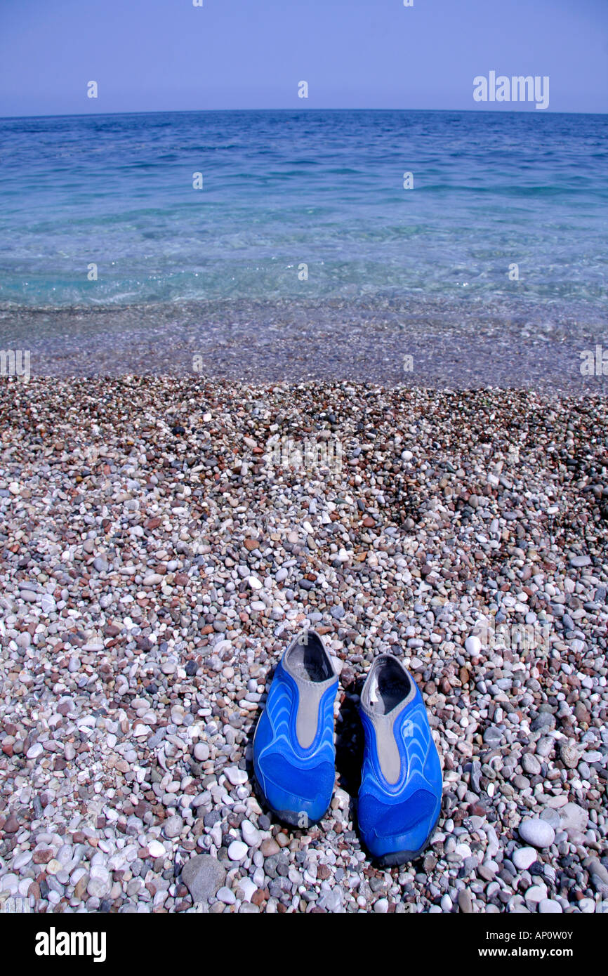 blue sport shoes on pebble beach Stock Photo - Alamy