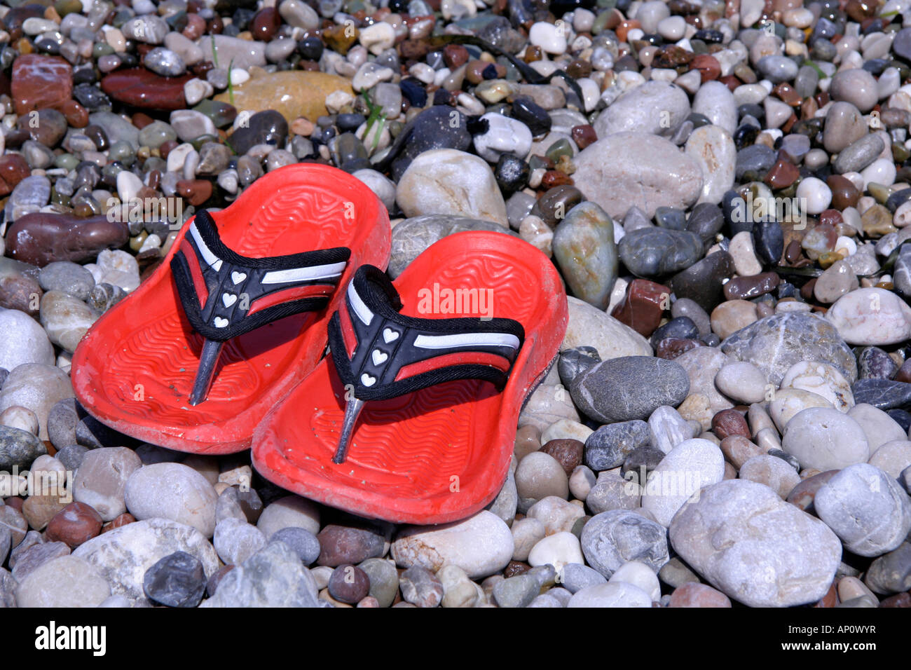 red heart shoes on pebble beach Stock Photo - Alamy