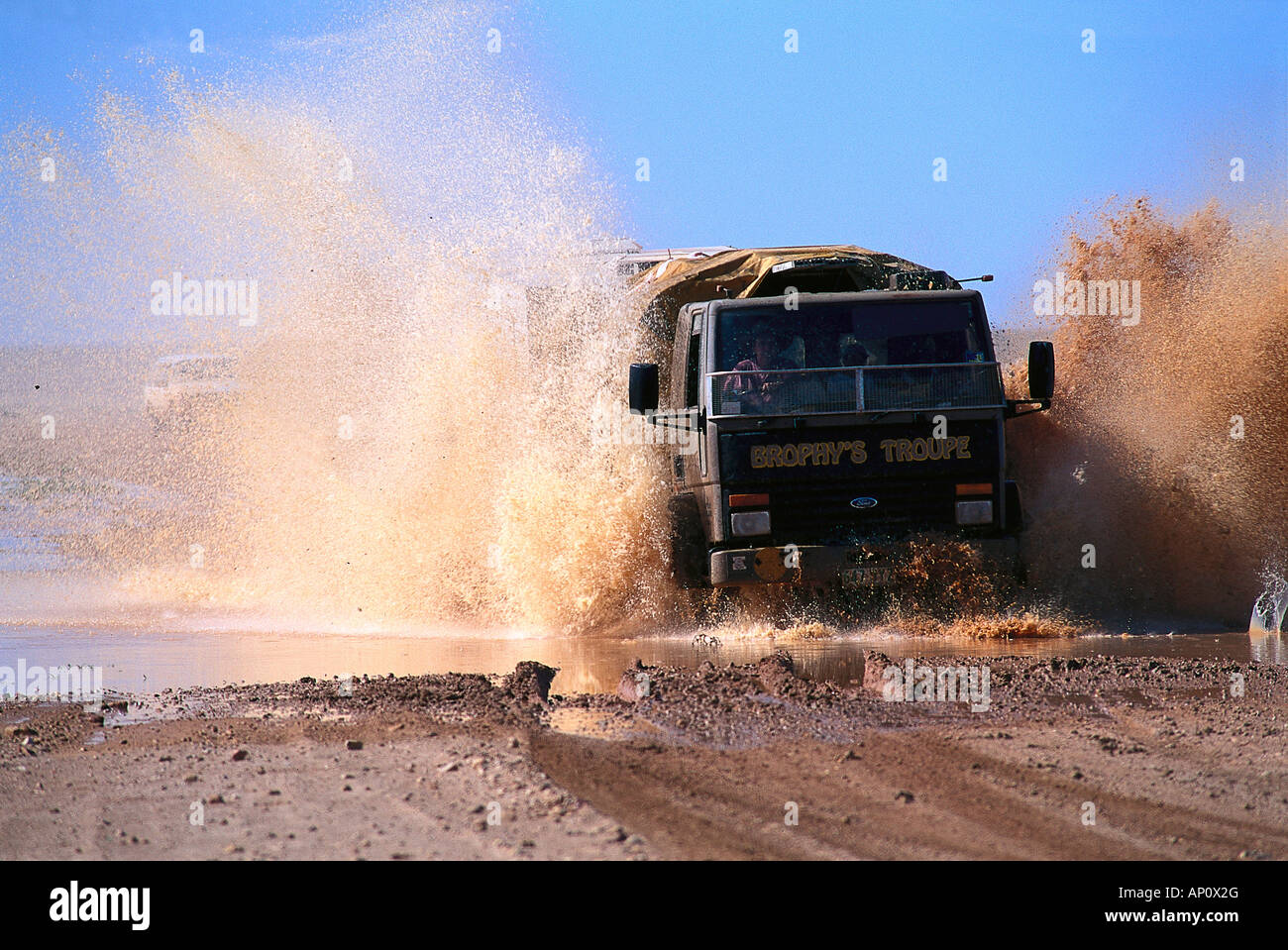 Truck of Fred Brophy's Boxing Troupe driving through water, Outback ...