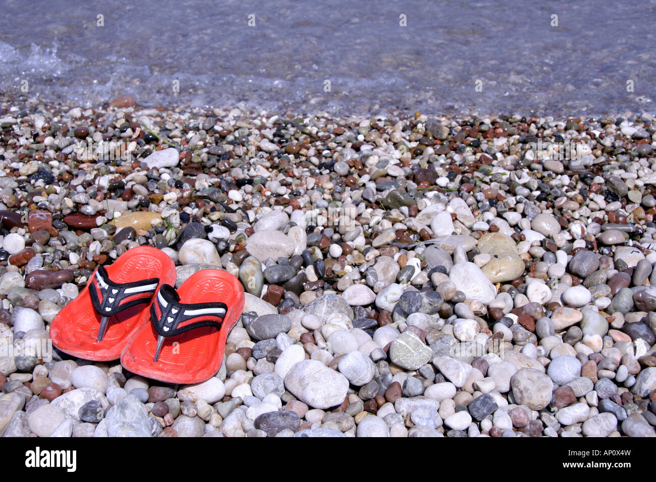red heart shoes on pebble beach Stock Photo - Alamy
