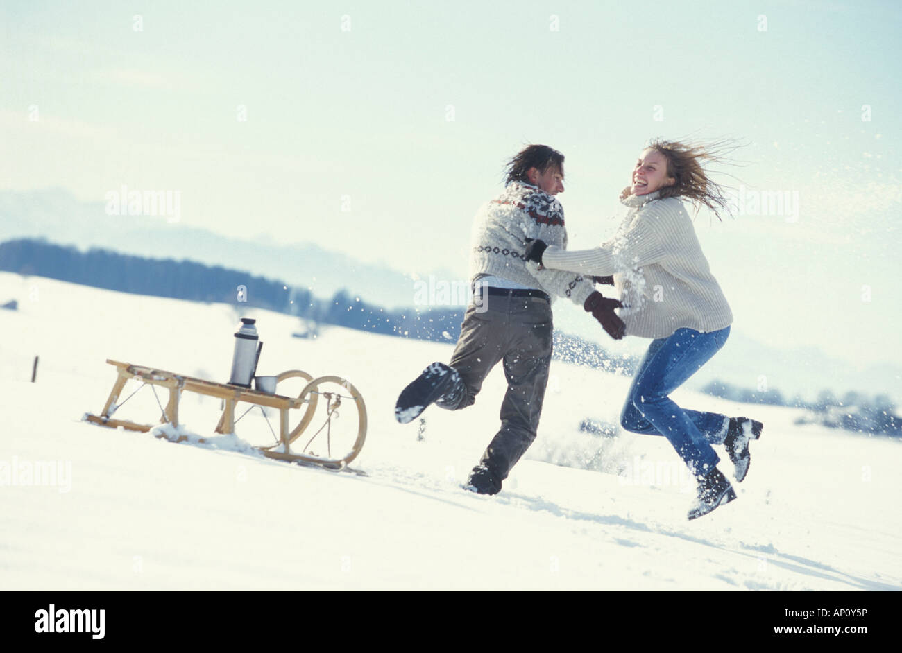 Couple playing in the snow, Winter landscape Stock Photo - Alamy