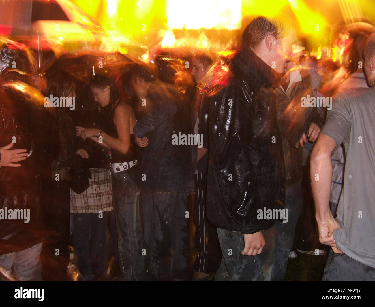 crowd of revellers in concert in pouring rain Stock Photo - Alamy