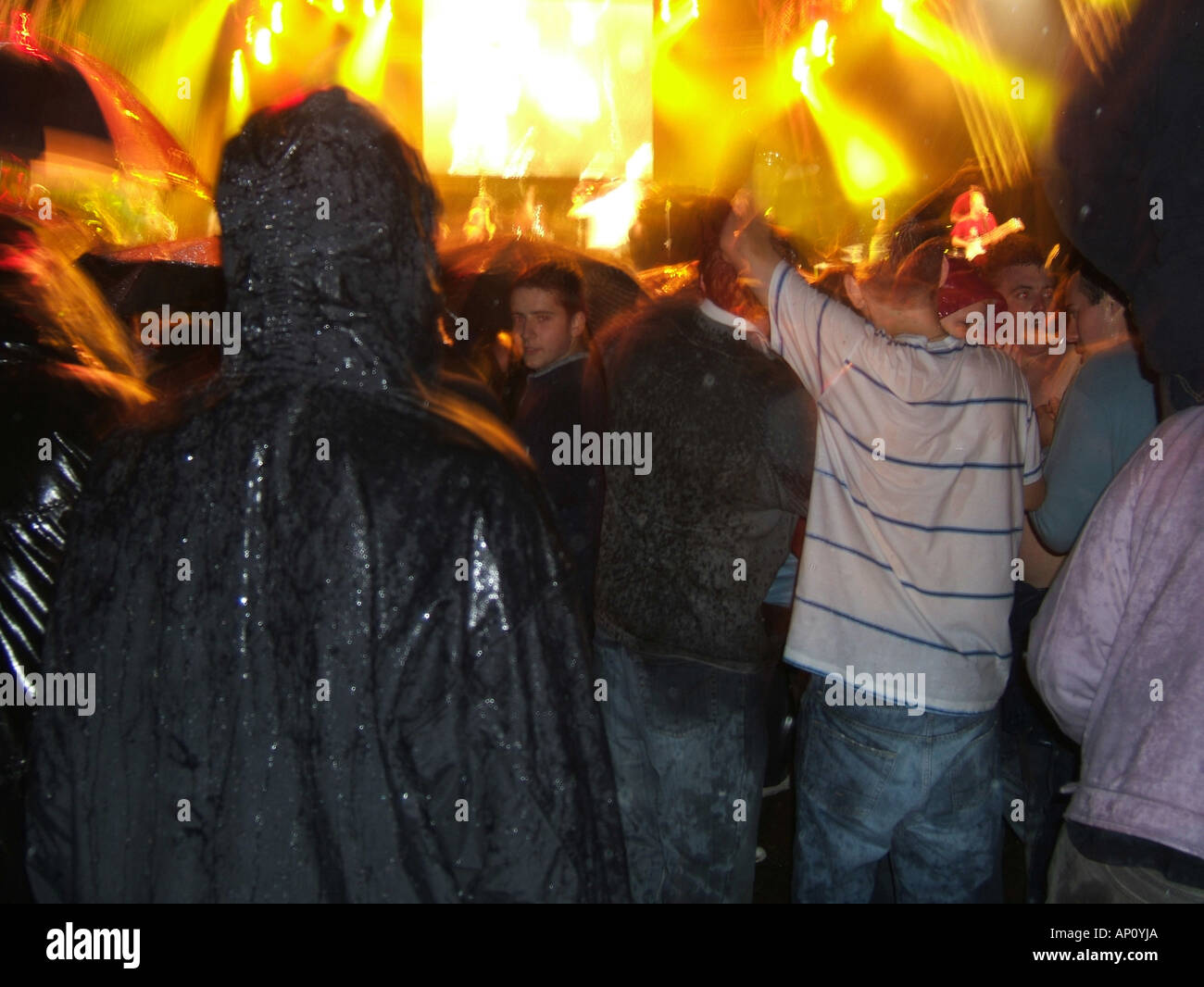 crowd of revellers in concert in pouring rain Stock Photo - Alamy