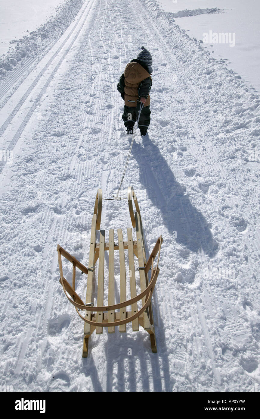 Small Boy pulling Sledge, Small boy pulling sledge on snow, Galtuer ...