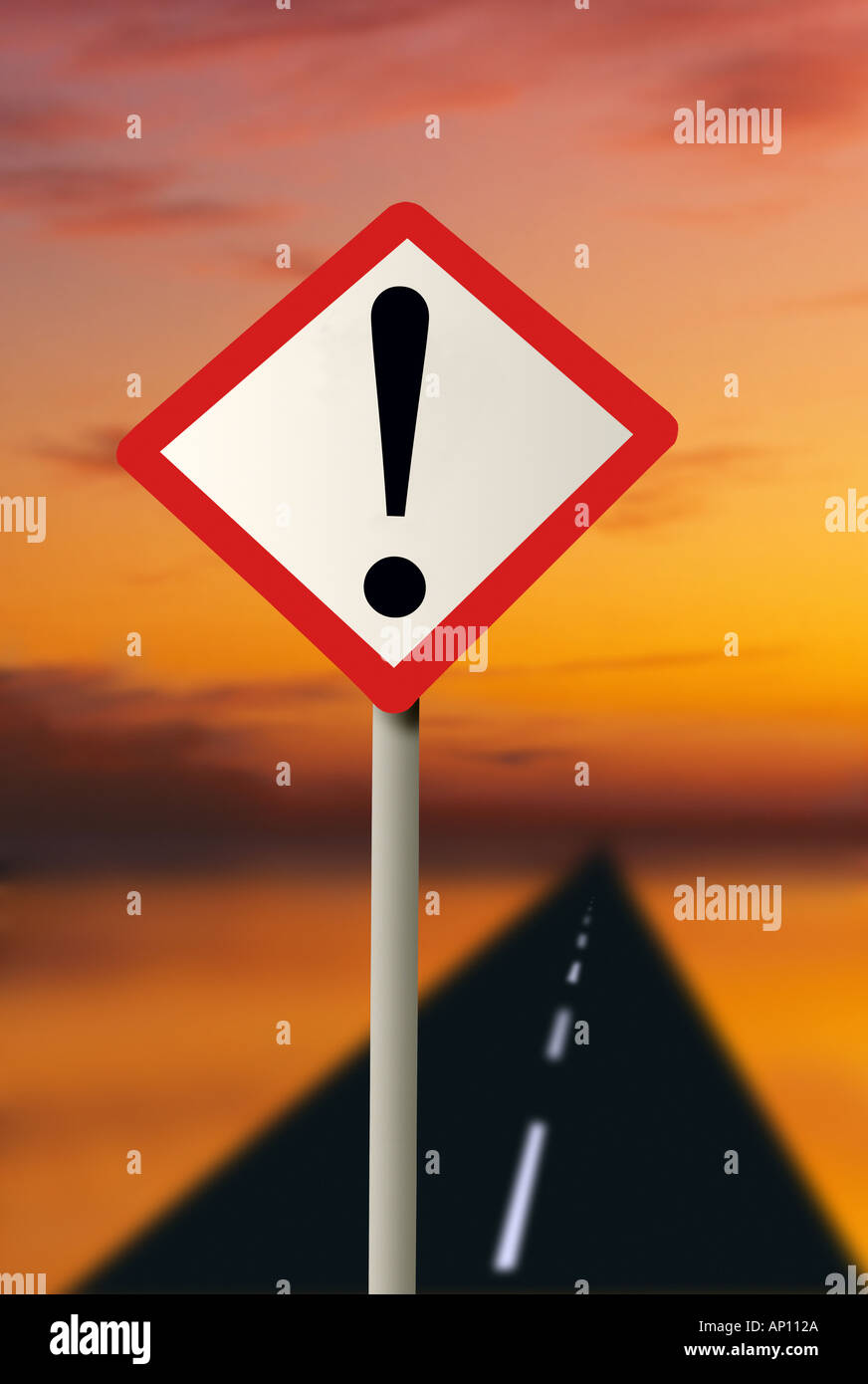 Road sign with an exclamation mark symbol Road and sunset sky in ...
