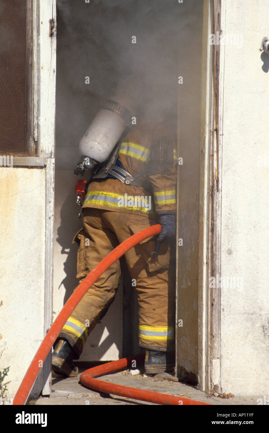 Firefighter entering building hi-res stock photography and images - Alamy